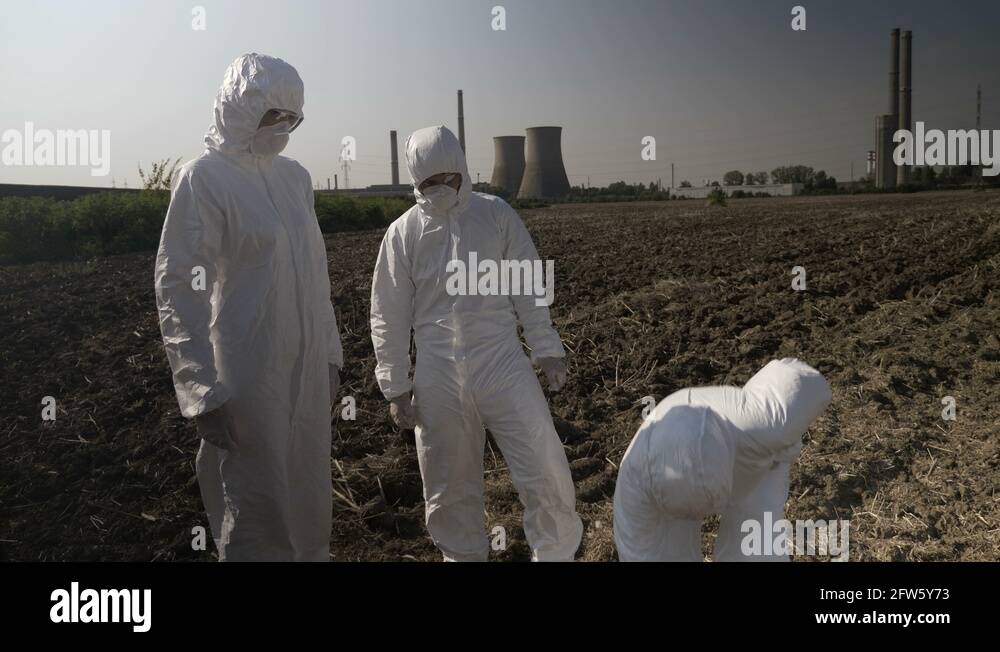 Technical team of lab employees in hazmat suits sampling and examining ...