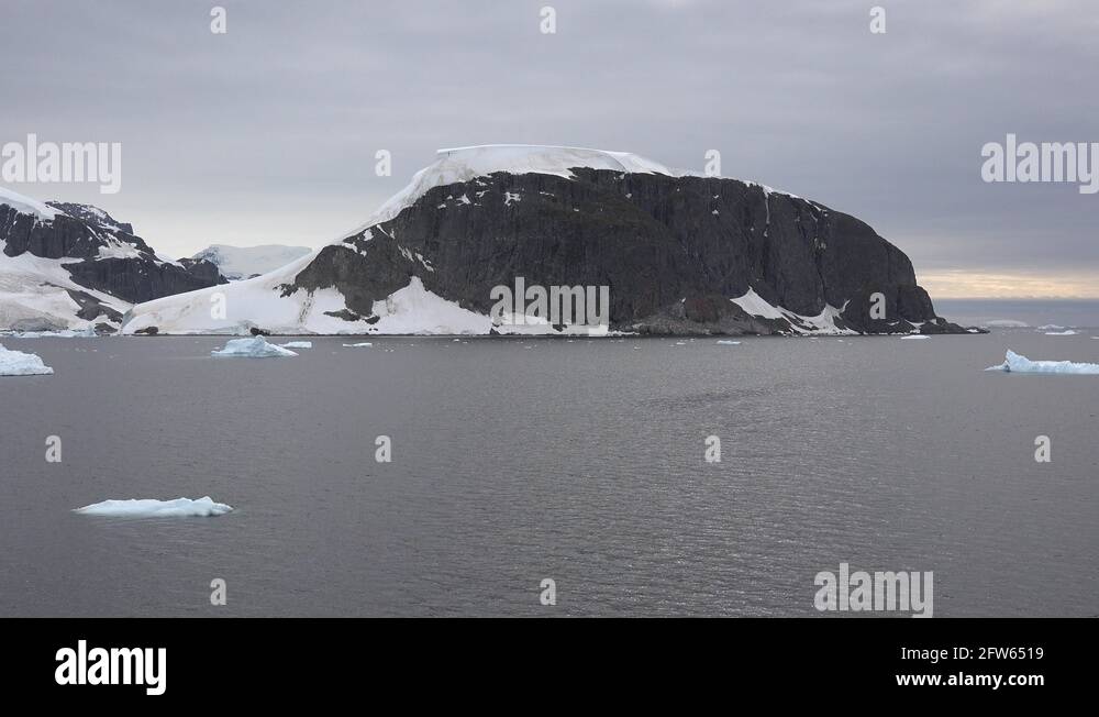 Antarctica black rock rising from water Stock Video Footage - Alamy