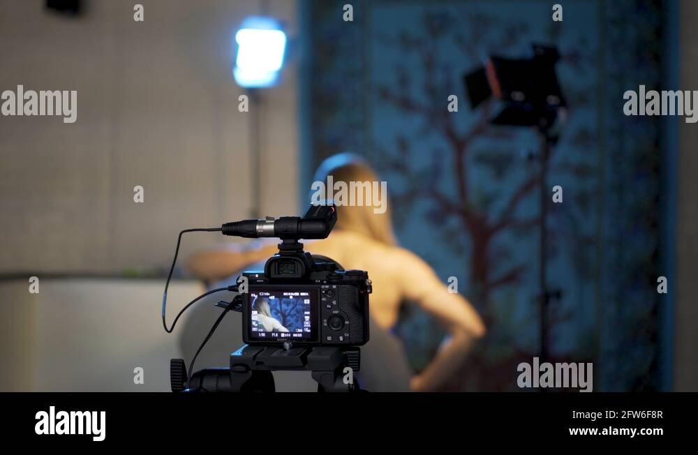 Focus shift from cameraman helping talent with mic and going back to ...