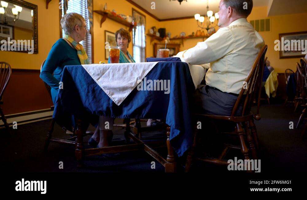 Camera boom up at a table of business people at a luncheon in a ...