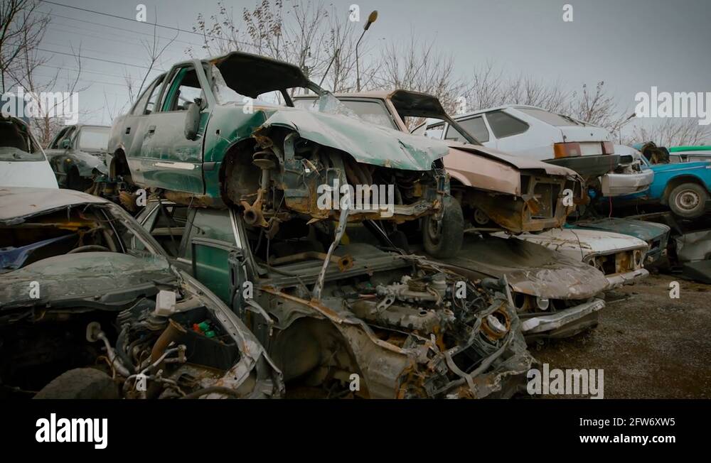 close up shot of the broken cars that are on the landfill of vehicles ...
