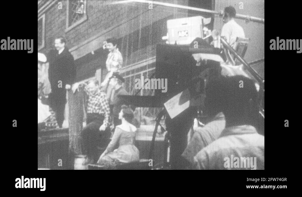 1950s: actors on set, camera and orchestra in TV studio. office ...