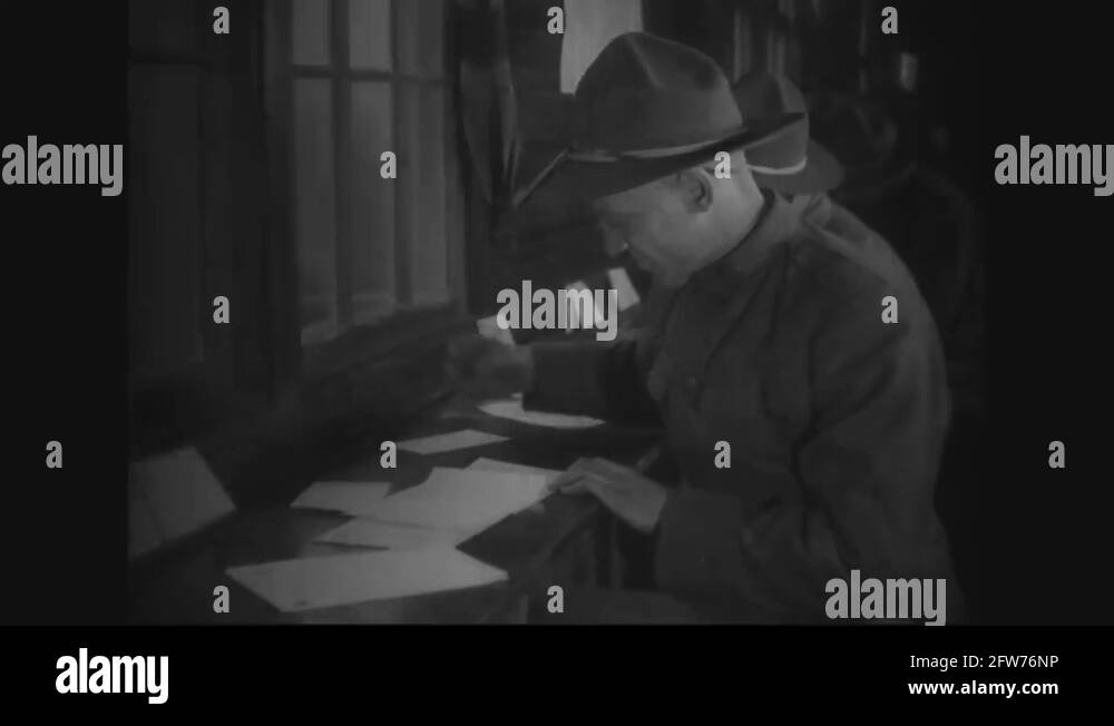 Enlisted men sit and write a letter and put it into the envelop - 1917 ...