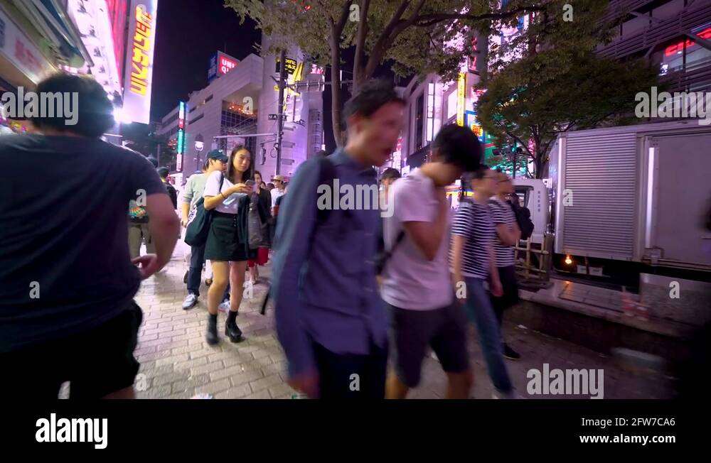 People cross the famous intersection in Shibuya, Tokyo, Japan Stock ...