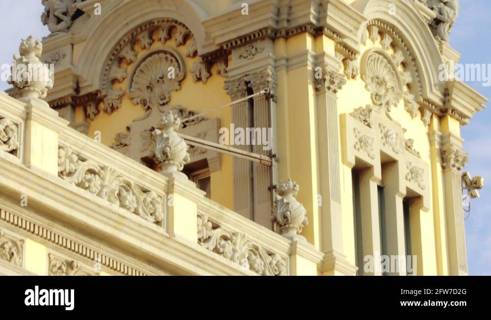 Historical building with tall tower and statues. Stone facade building ...