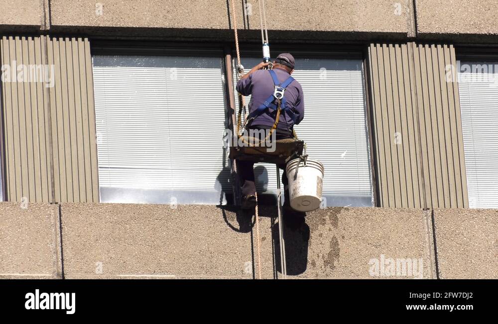 window washers slides down his rope and pulley system to wash another ...