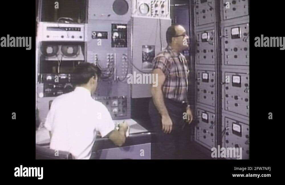 1970s: UNITED STATES: scientists work at research facility. Jet engine ...