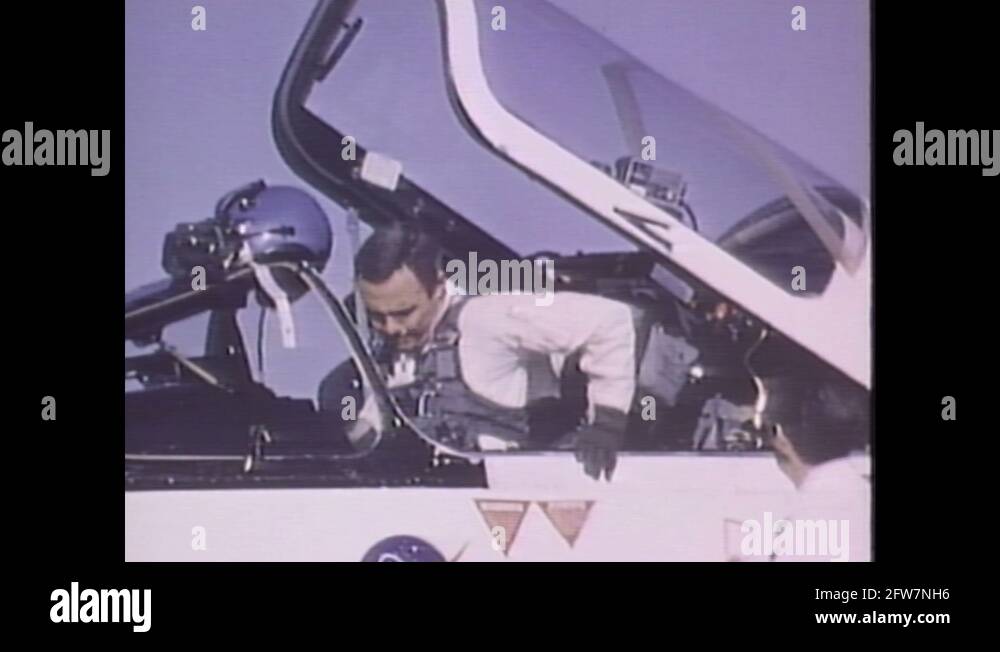 1970s: UNITED STATES: test pilot climbs into plane cockpit ...