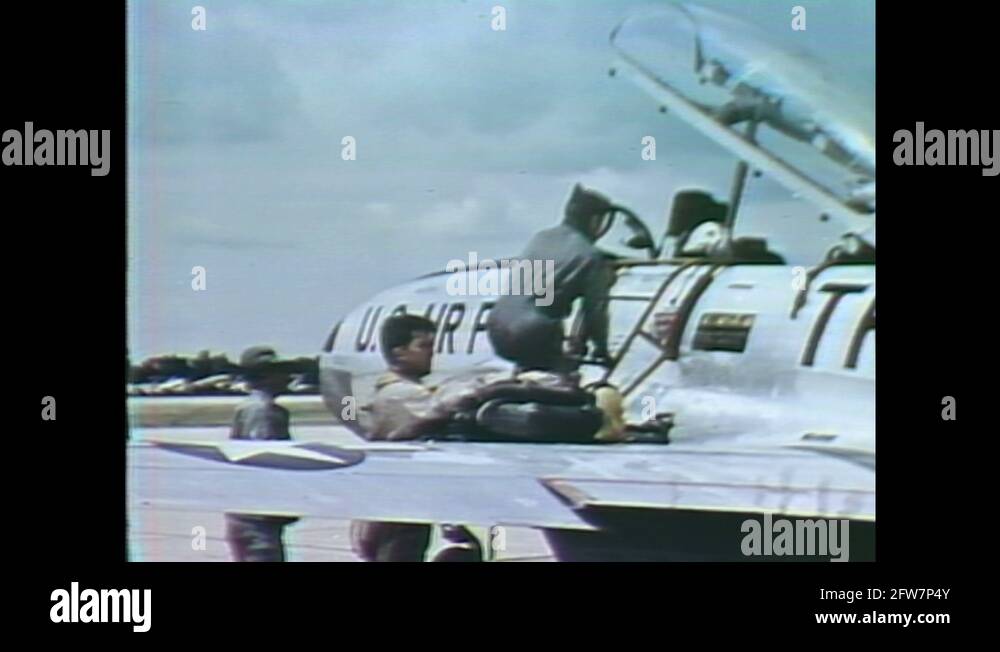 1960s: Air Force pilots put on gear and climb into cockpit of fighter ...