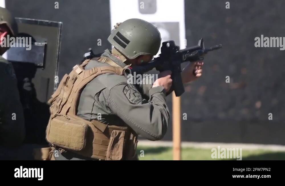 SRT officers in uniforms performing at the shooting range with rifles ...