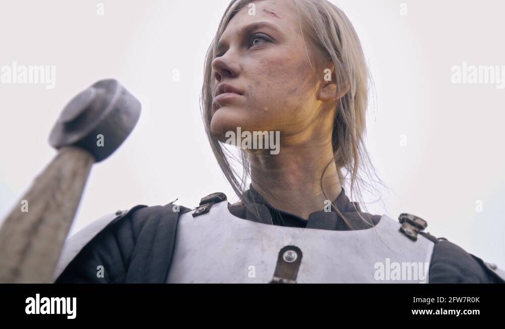 A sad woman in medieval armor squeezes her sword and cries Stock Video ...