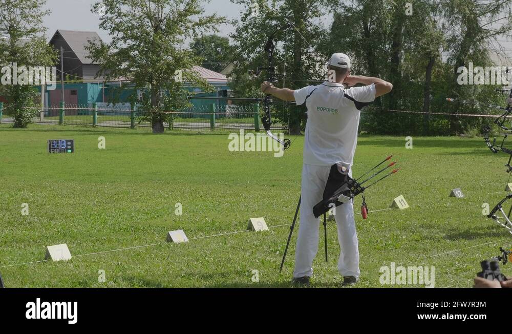 Attractive male archer bending a bow and aiming in the target Stock ...
