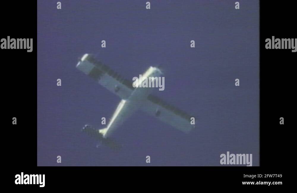 1970s: Model airplane flies, spirals and turns upside down in air Stock ...