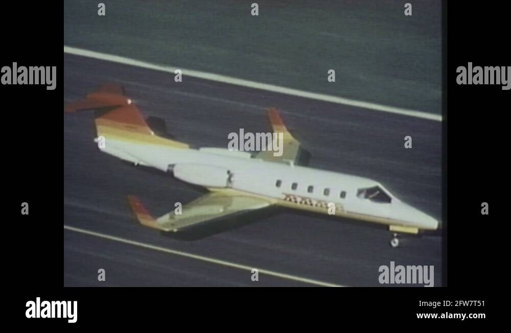 1980s: Jet plane taxis down runway then takes off. Jet plane flies ...