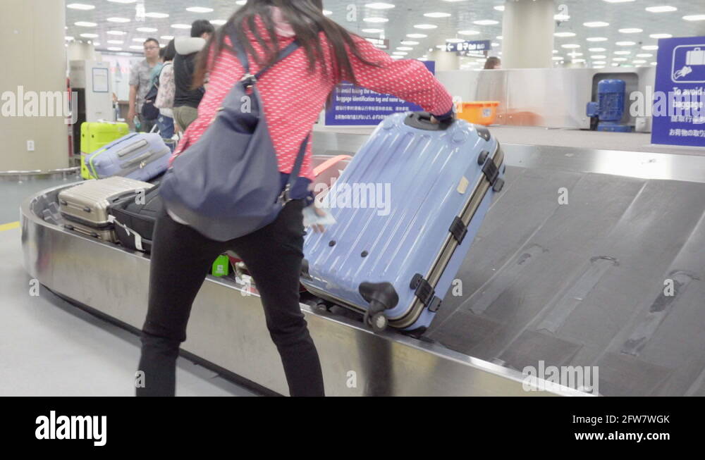 Passengers taking suitcases from moving conveyor belt Stock Video ...