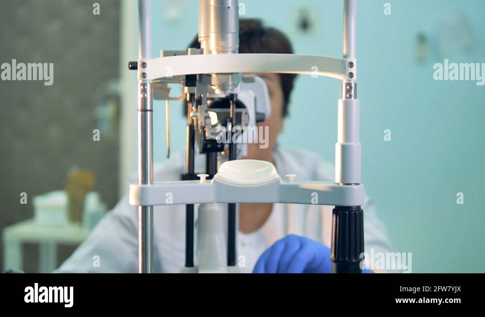 An ophthalmologist moves internal parts of a slit lamp Stock Video ...