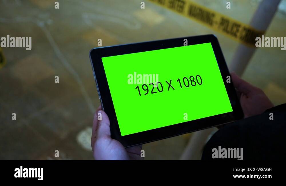 Crime Scene Investigator holding an tablet with green screen at an ...