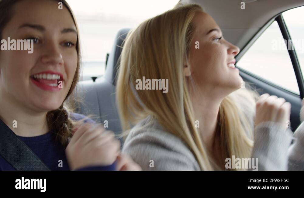 Best Friends Do Dance Moves Together In Back Seat Of Car, They Smile ...
