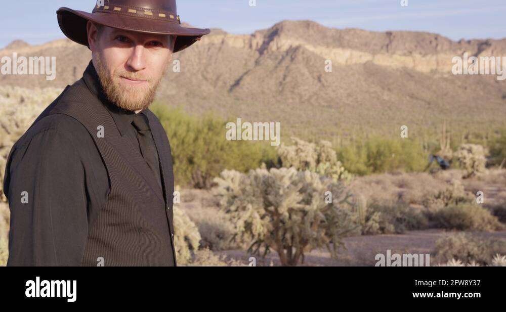 Creepy Cowboy stares towards camera as he walks - villain Stock Video ...