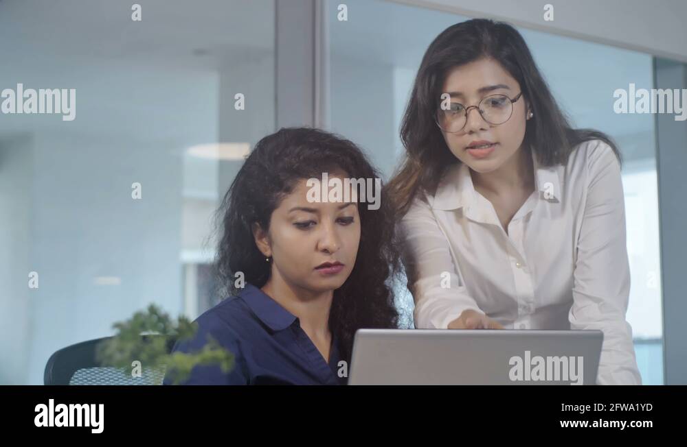 Two Indian beautiful office women working together on a laptop, India ...