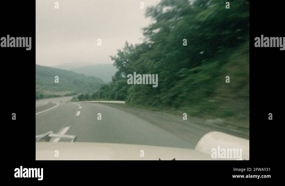 1950s: Tracking shots from car, driving down highway. Approaching ...