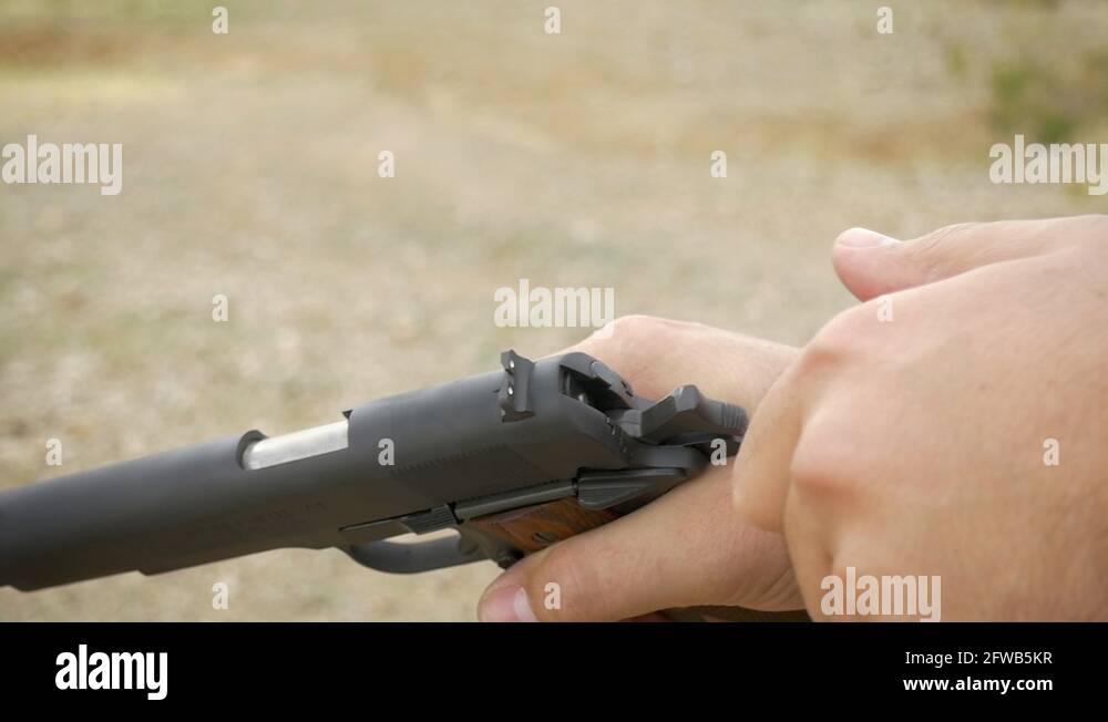 Man Loading a Handgun Releases a Round into the Chamber in Slow Motion ...