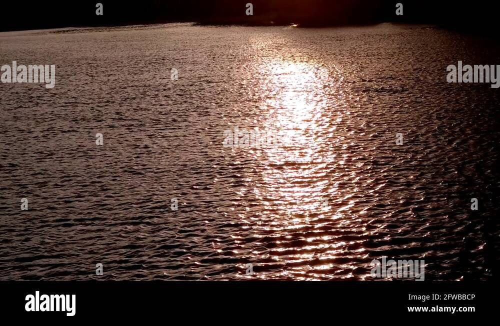 Sunlight Reflection in Water in the sunset, Sea waves with sun setting ...