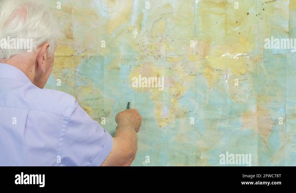Senior man looking at an old map Stock Video Footage - Alamy