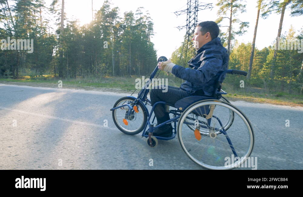 Disabled person rides a wheelchair bicycle, side view Stock Video ...