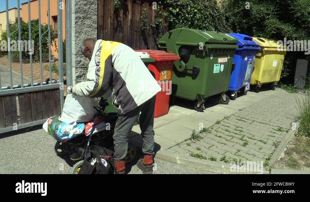 Homeless poor chooses a dustbin paper container bin garbage, very ...