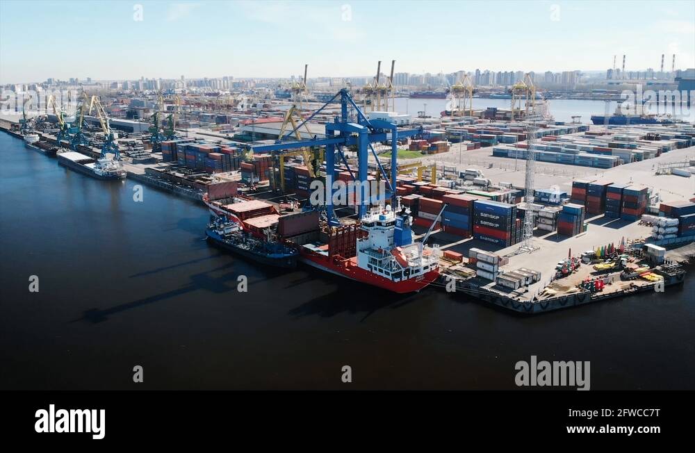 Loading of cargoes on the cargo container ship on landing stage Stock ...