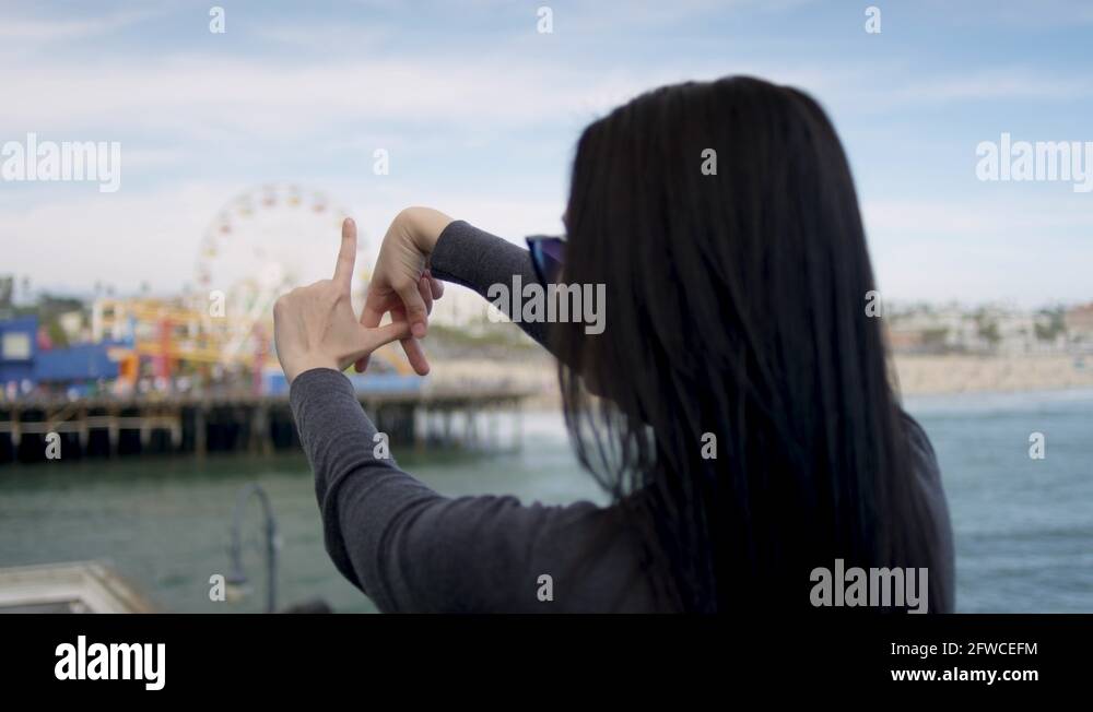 Young Woman Makes An LA Hand Symbol, Her Back To Camera Stock Video ...