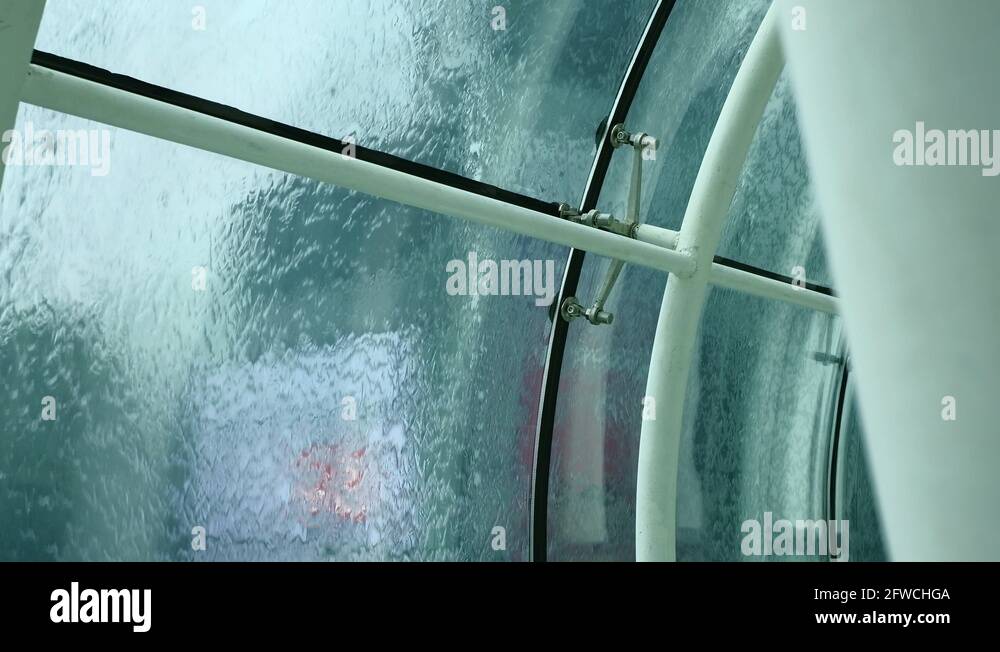 Singapore - Rain water pouring on window with column in foreground. 4K ...