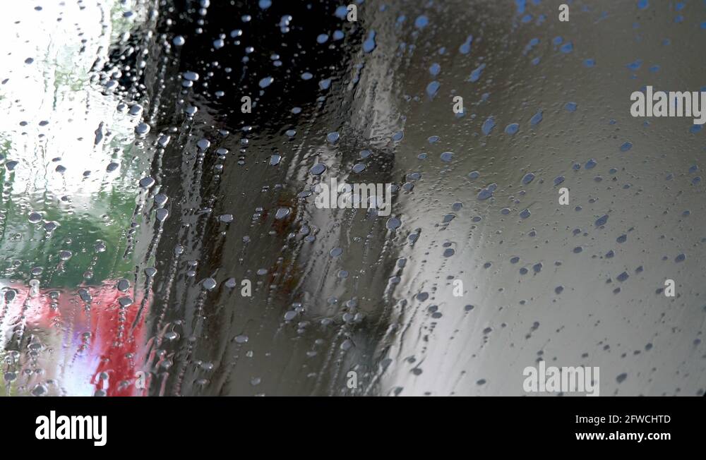 Closeup of windscreen or windshield of car going through a touchless ...
