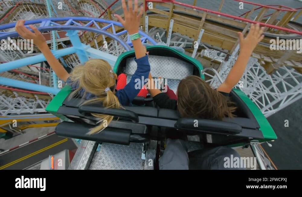 Amusement Park Excitement. A Fairground With Carnival Rides And Happy ...