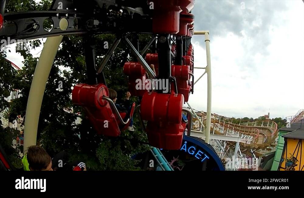 Amusement Park Excitement. A Fairground With Carnival Rides And Happy ...
