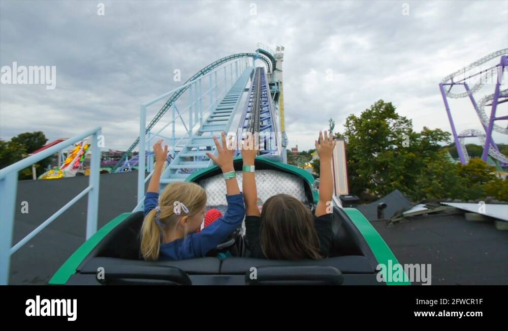 Amusement Park Excitement. A Fairground With Carnival Rides And Happy ...