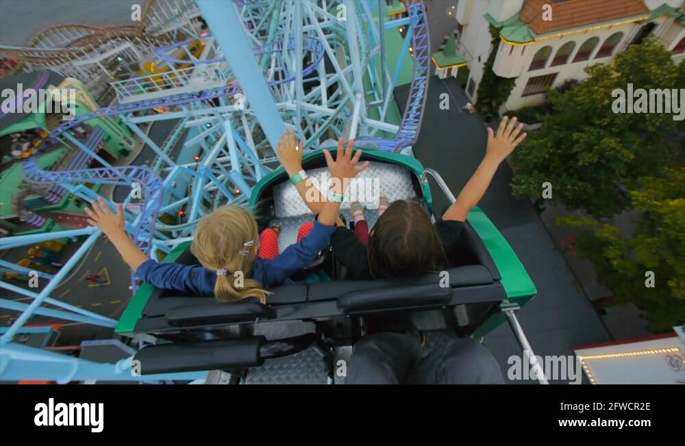 Amusement Park Excitement. A Fairground With Carnival Rides And Happy ...