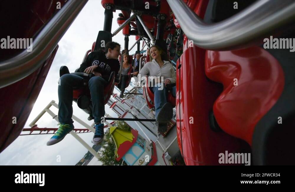 Amusement Park Excitement. A Fairground With Carnival Rides And Happy ...