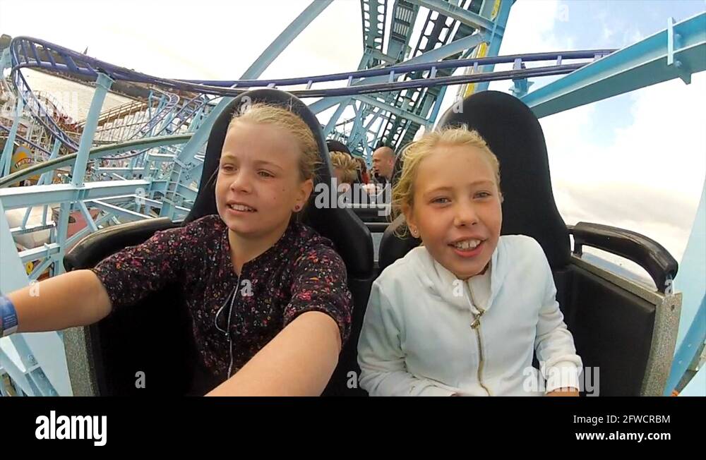 Amusement Park Excitement. A Fairground With Carnival Rides And Happy ...