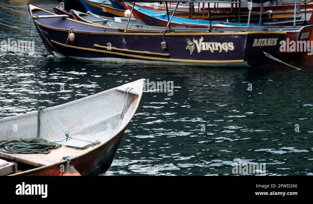 A small manned fishing boat arriving a harbor in Batanes, Philippines ...