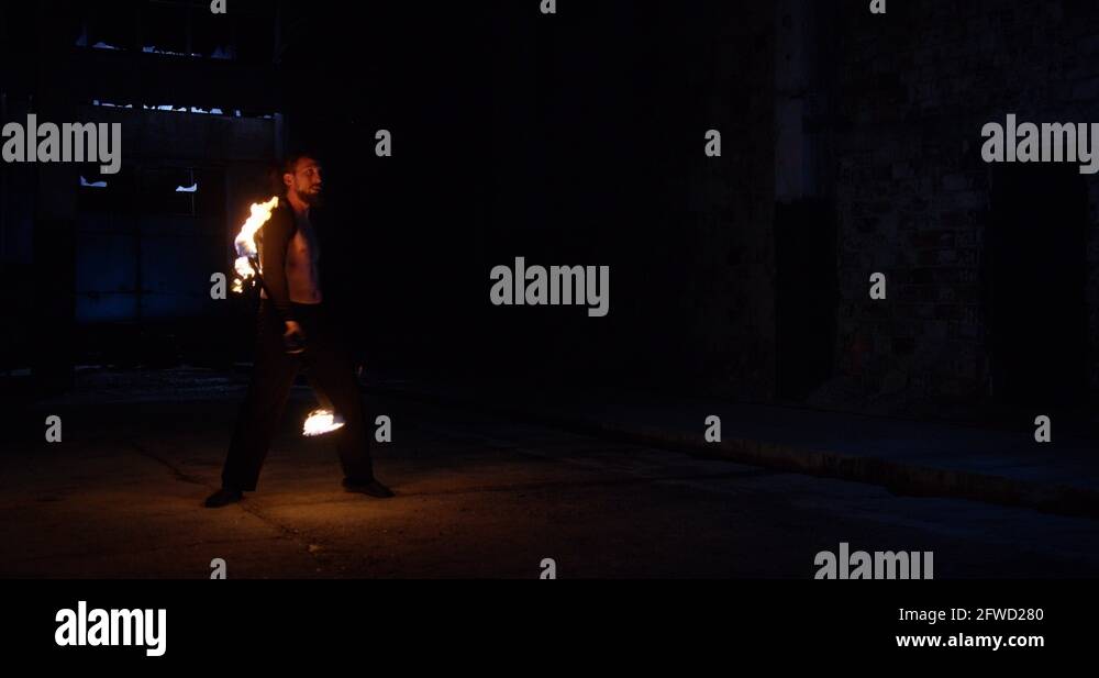 Male Fire Spinner Spinning Fire Poi In Abandoned Building Dangerous ...