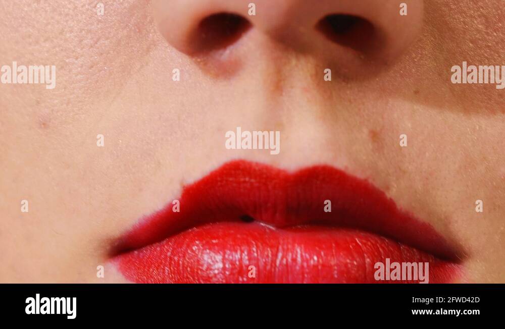 Extreme Close Up, Woman with red lips lighting and smoking a cigarette ...