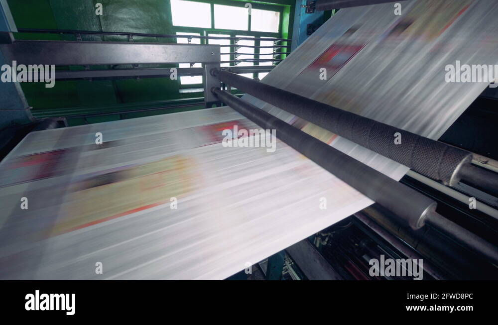 Printing equipment moves paper sheets on a line at a factory. 4K Stock ...