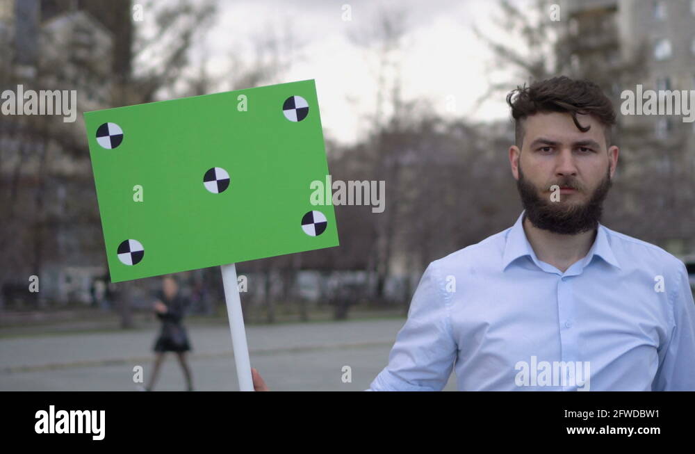 Picket man. The guy is looking at the camera. Banner with points for ...