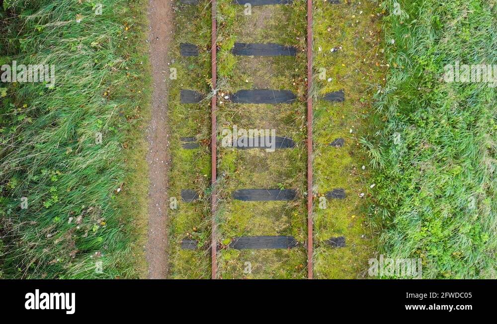 Birds eye view following old rusty abandoned rail tracks. MOVING ...