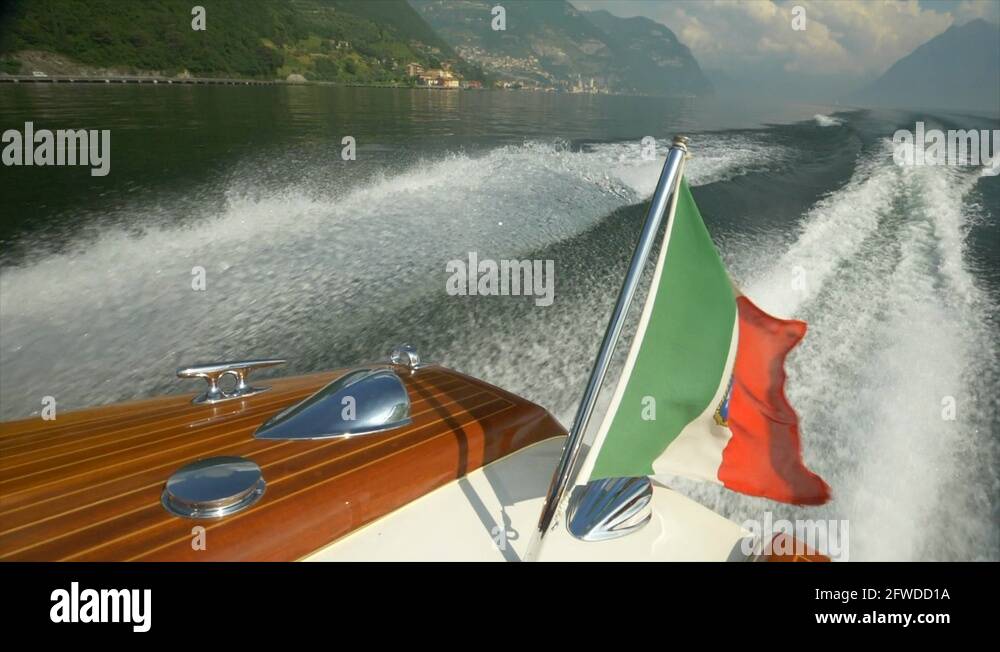 Italian flag on a classic luxury wooden runabout boat on an Italian ...