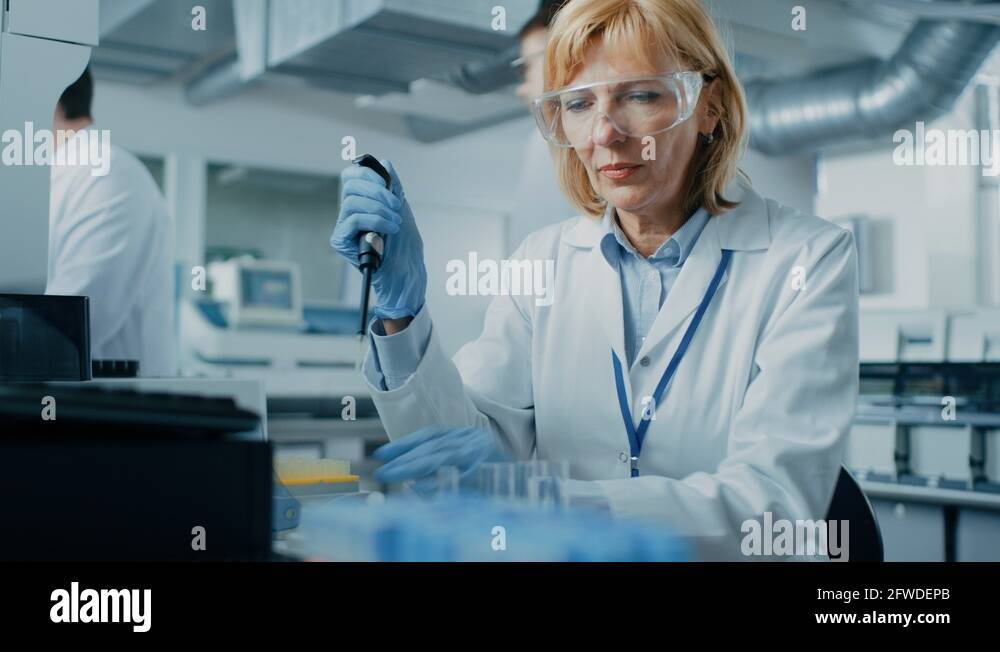 Female Research Scientist Uses Micro Pipette while Working with Test ...