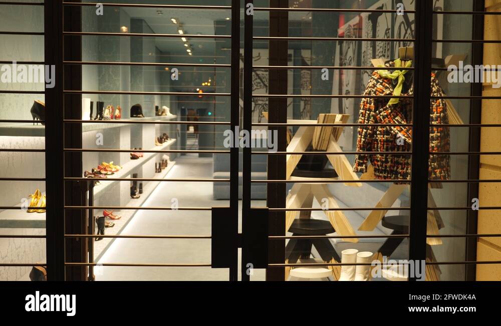 MIU MIU store in Paris, France. Tilt up from shop window to logo above ...