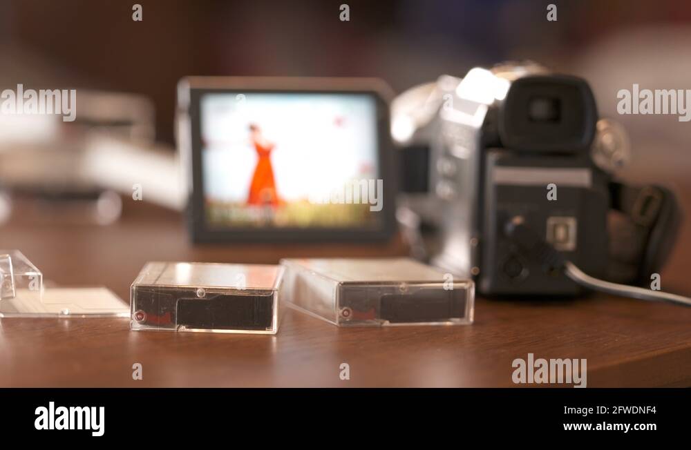 Man watching family home video on LCD screen of digital Mini DV ...